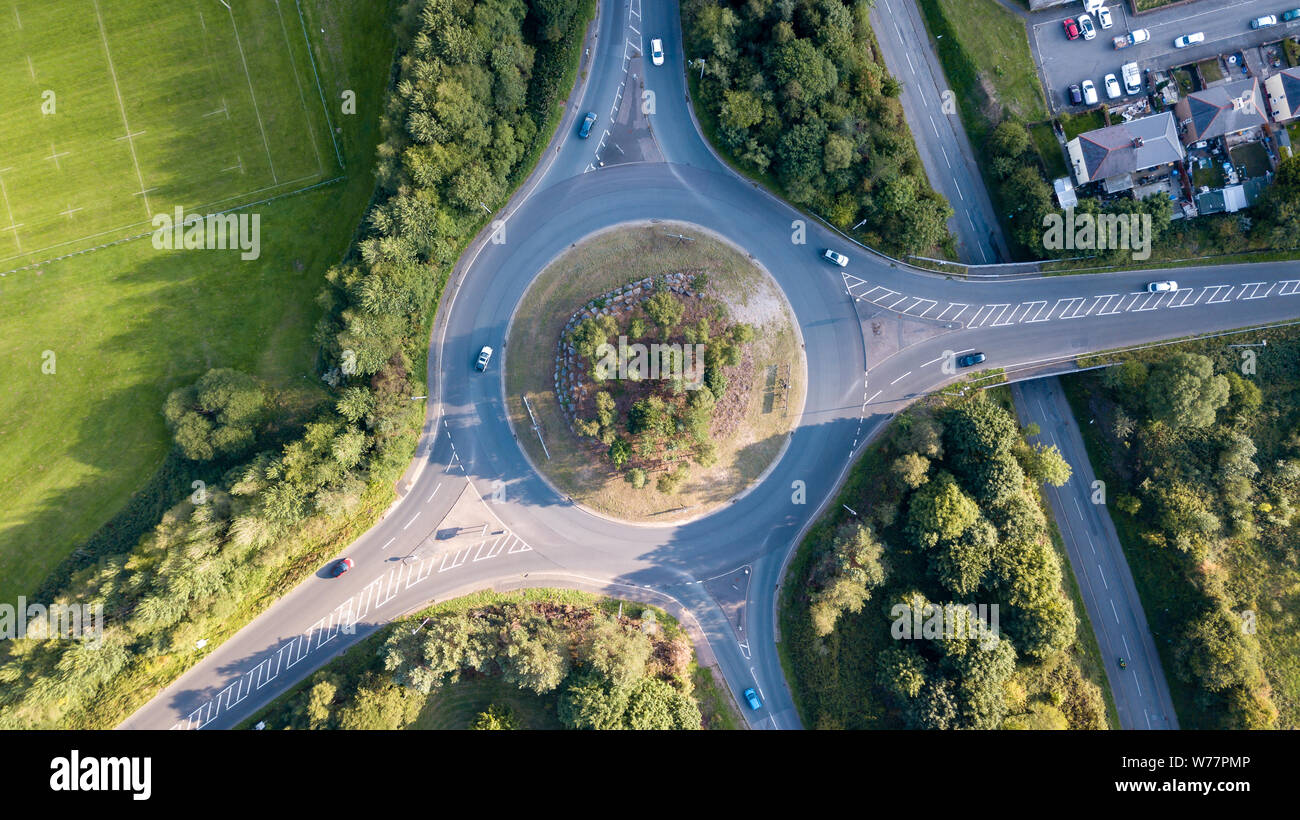 Top down aerial view of a traffic roundabout on a main road in an urban ...