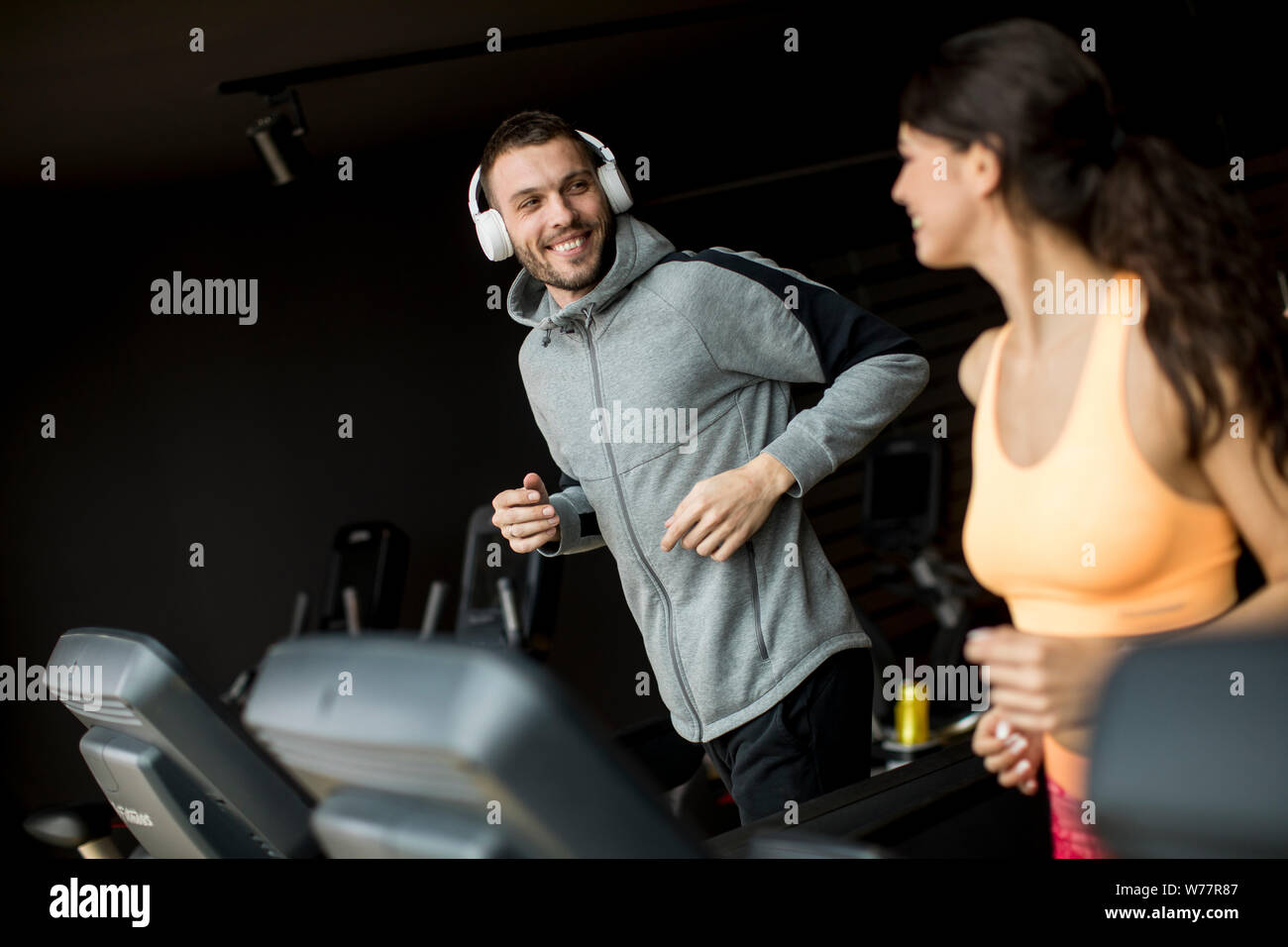 Group of young people using threadmill in modern gym Stock Photo - Alamy