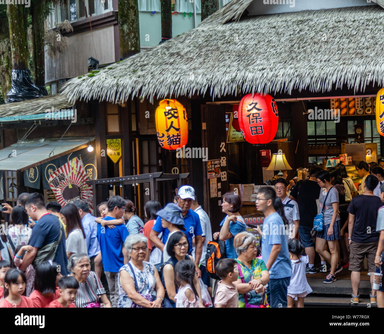 Nantou, Taiwan - August 3, 2019: Tourists walk around shops at Xitou ...