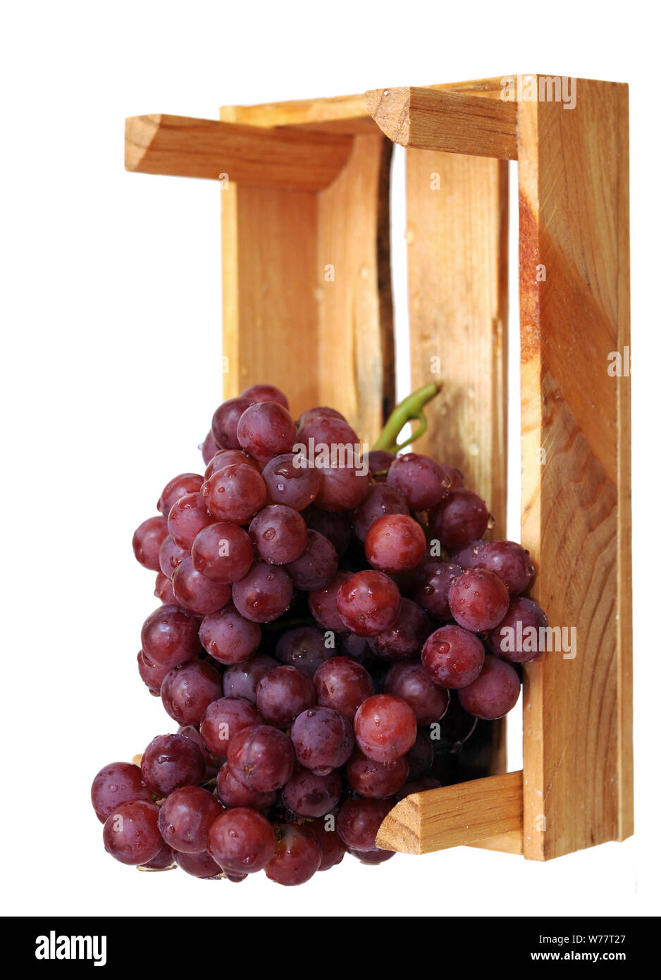 fresh red grapes falling out standing crate isolated on white Stock ...