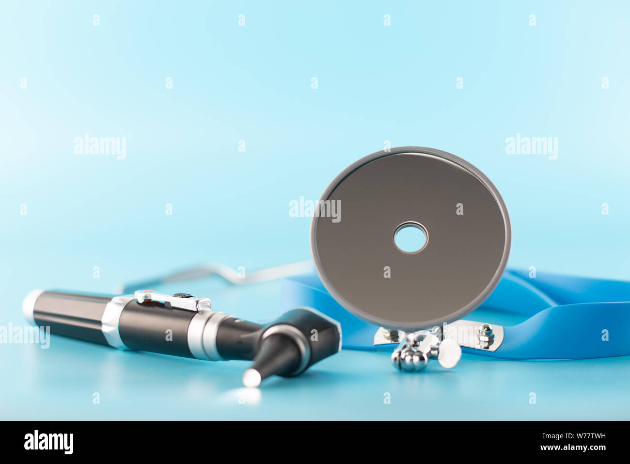 Ear professional instrument on blue background Stock Photo - Alamy