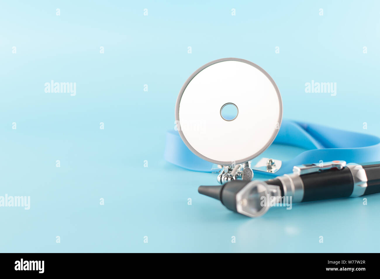 Ear professional instrument on blue background Stock Photo - Alamy