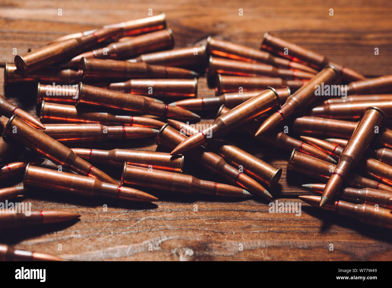 Bullets on a wooden background. Military concept Stock Photo - Alamy