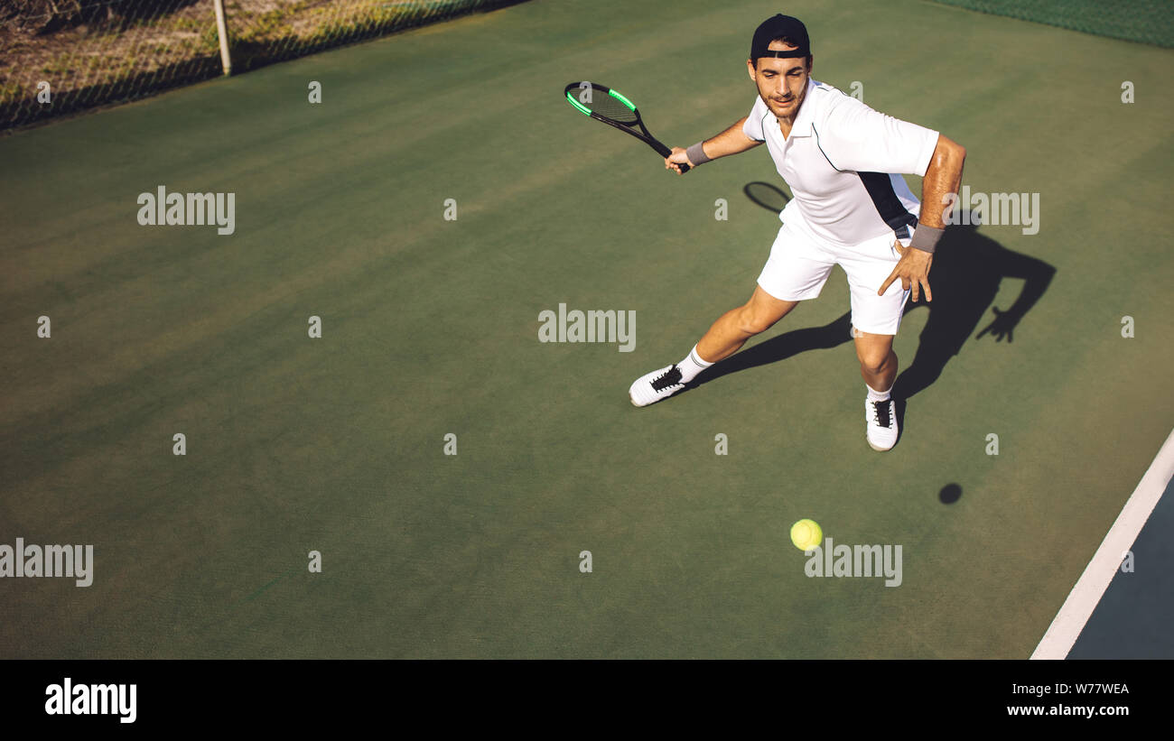 Professional tennis player hitting a forehand while playing on a hard ...