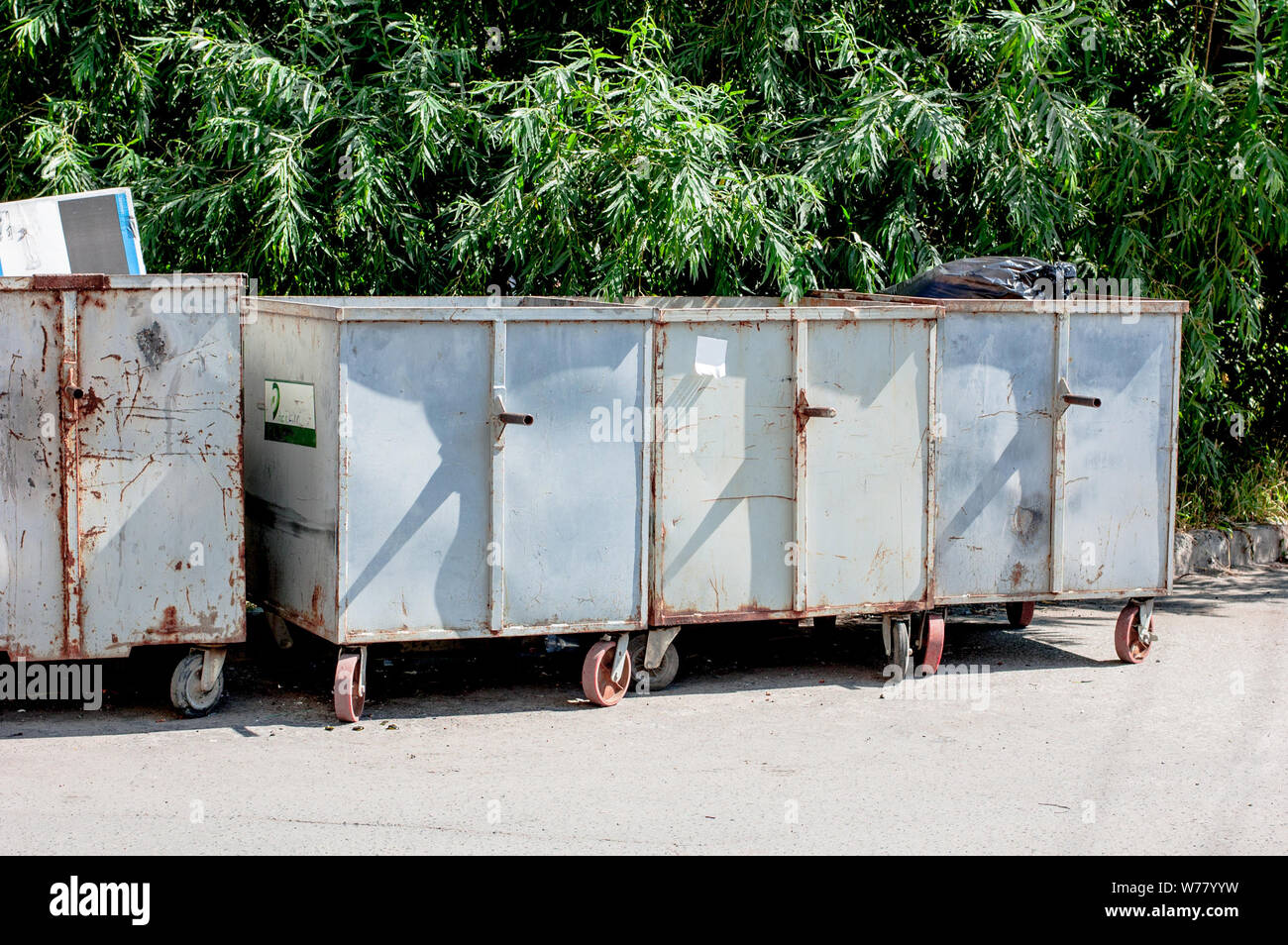 Garbage bins near housing block in a town in the summer Stock Photo - Alamy