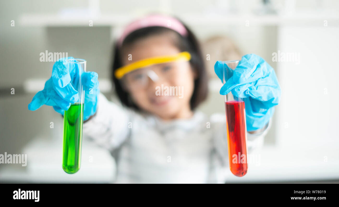 Happy asian kid with two glass tube when learning scientific in ...