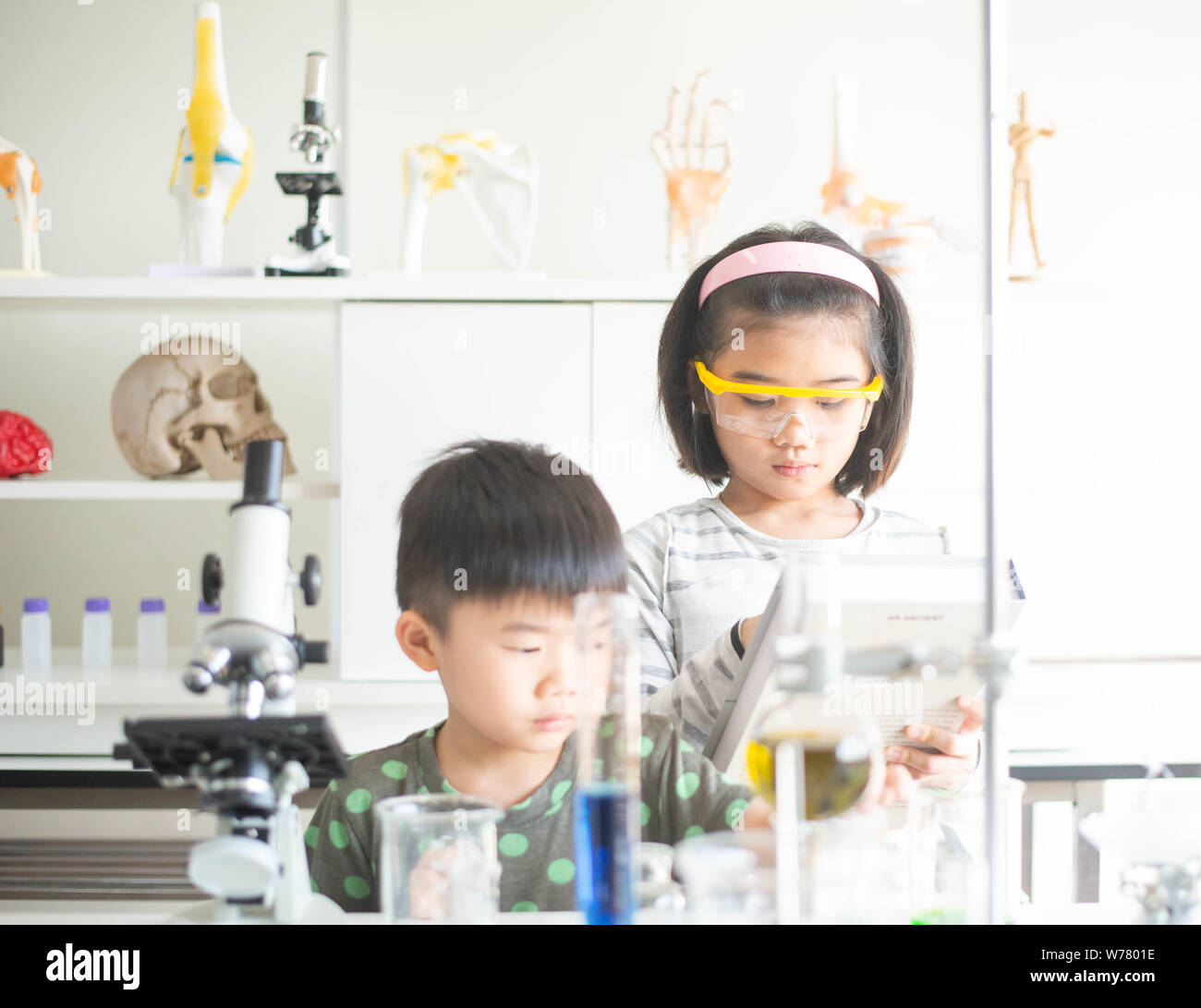 Two asian kids learning scientific in laboratory Stock Photo - Alamy