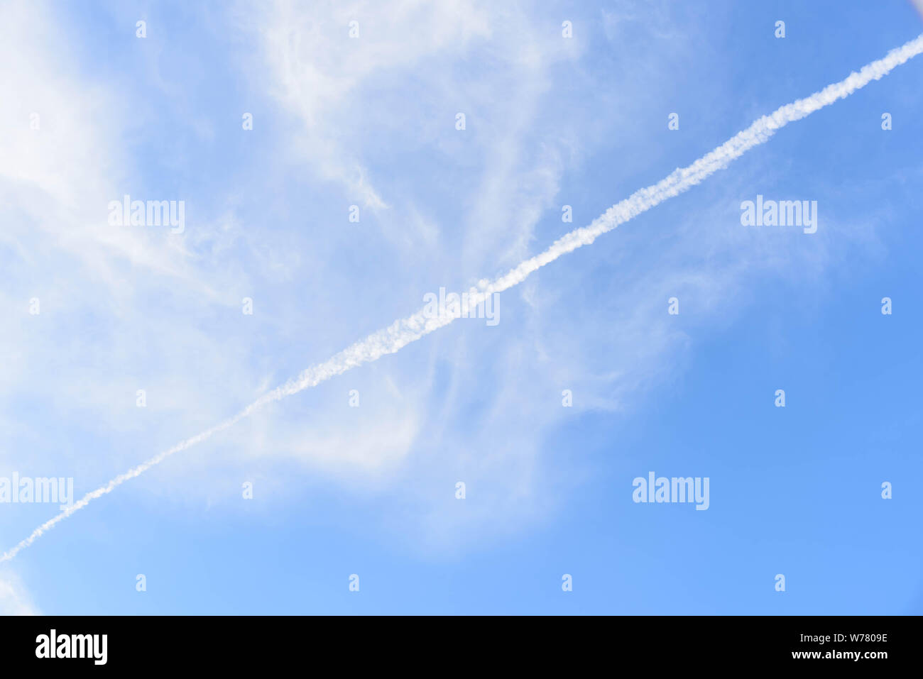 smoke of jet engine on blue sky Stock Photo - Alamy