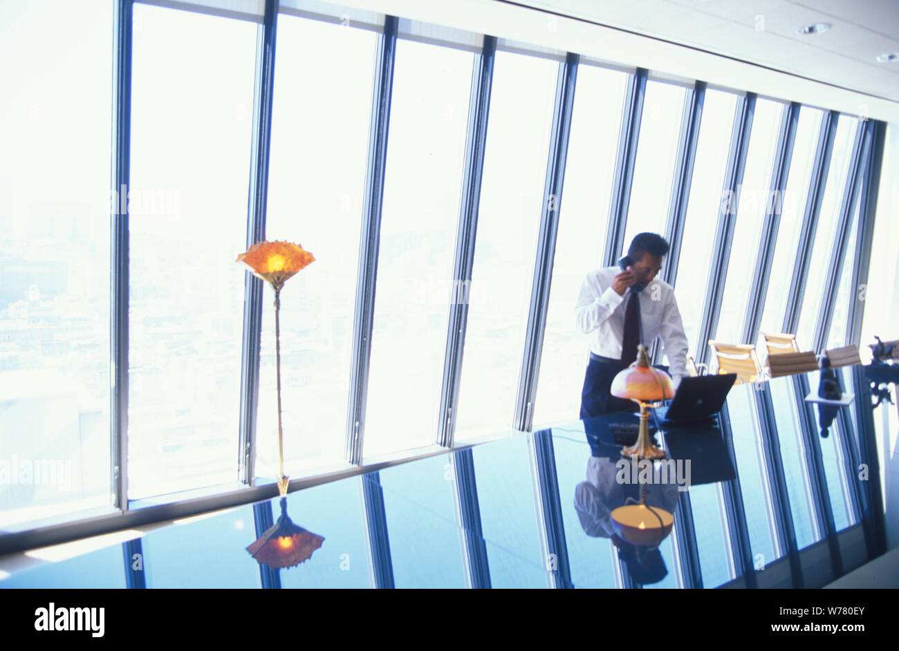 Side view of an executive using a phone Stock Photo - Alamy