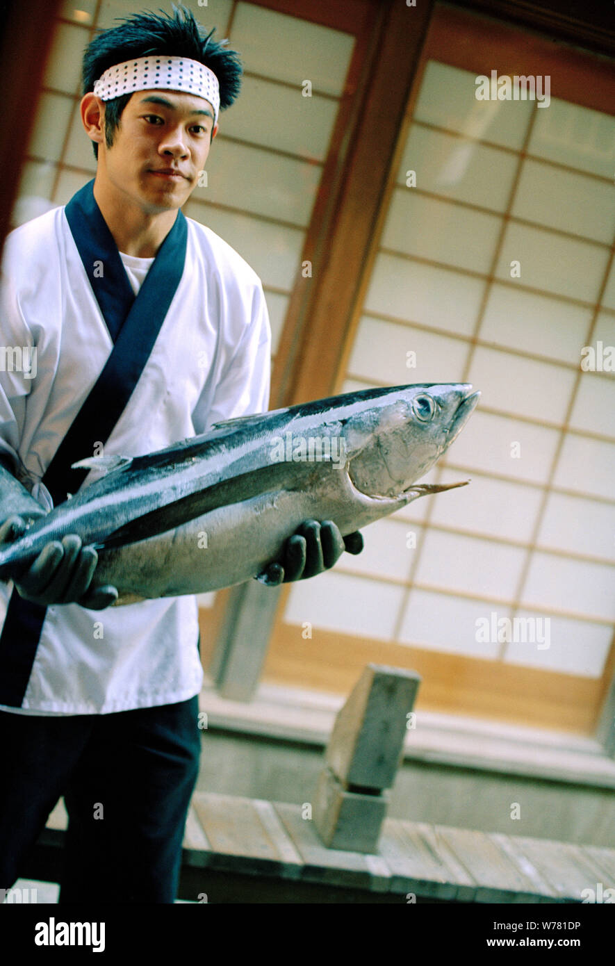 Portrait of a young man holding a large dead fish Stock Photo - Alamy