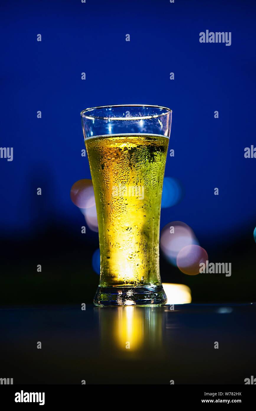 Cool beer glass in twilight - relax with beer in garden concept Stock ...