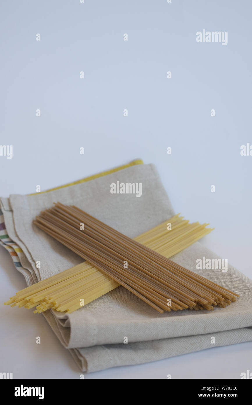 raw plain and wholemeal spaghetti togheter on a cloth Stock Photo - Alamy