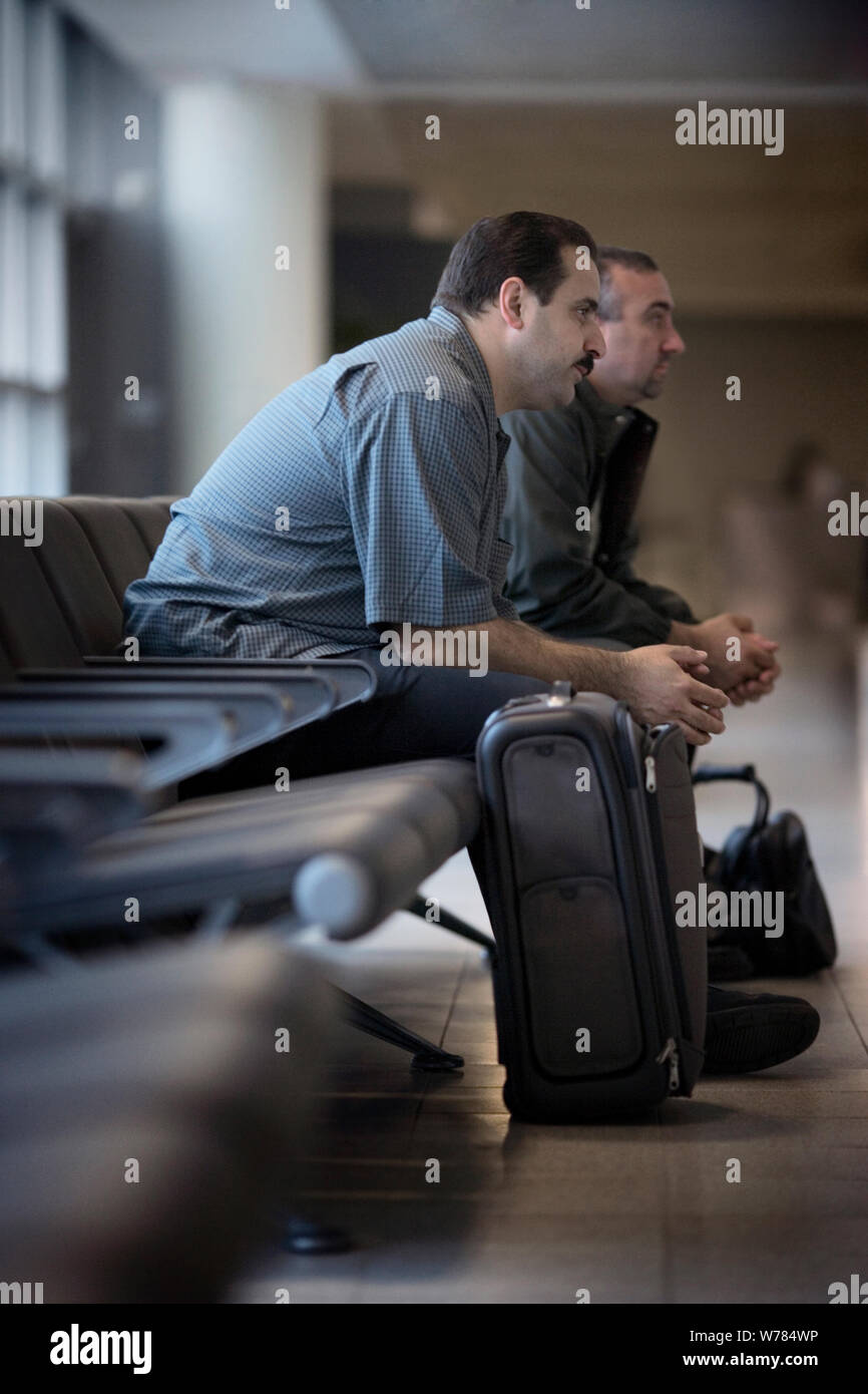 two men wait in airport Stock Photo - Alamy