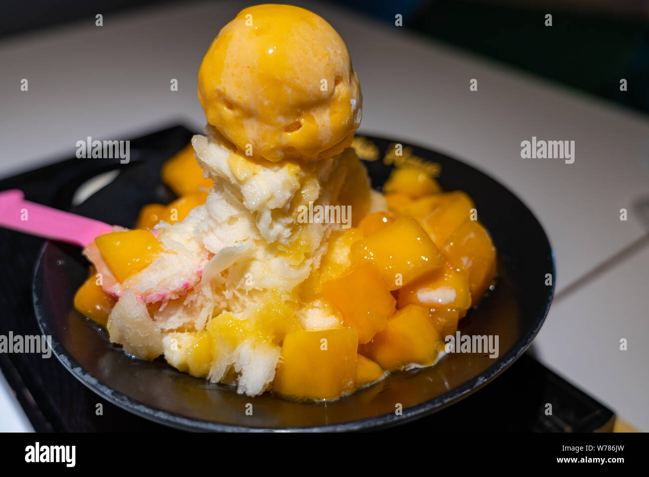 Mango fruit shaved ice and mango ice cream milk flavor serving with ...
