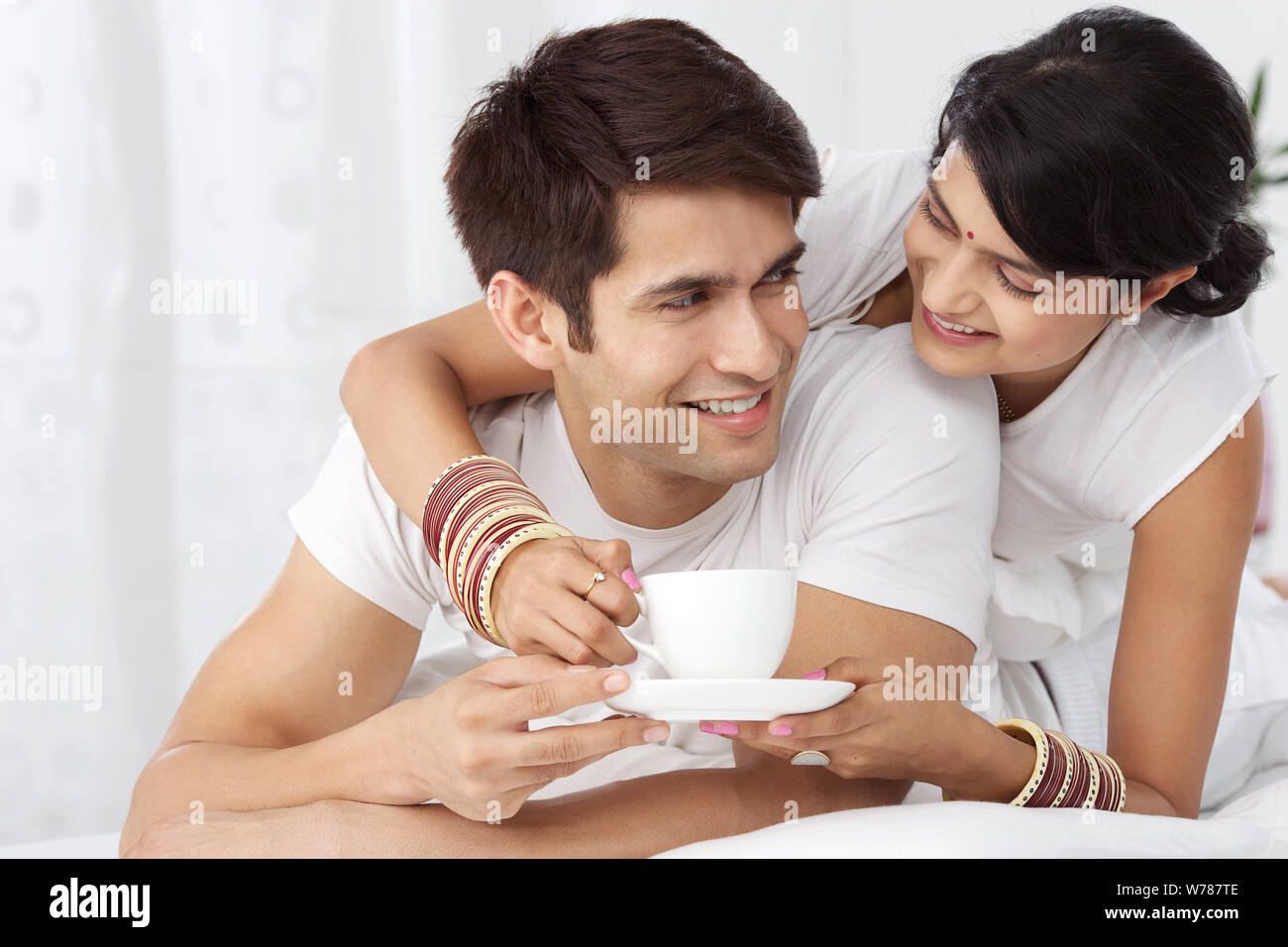 Newlywed couple having cup of tea Stock Photo - Alamy