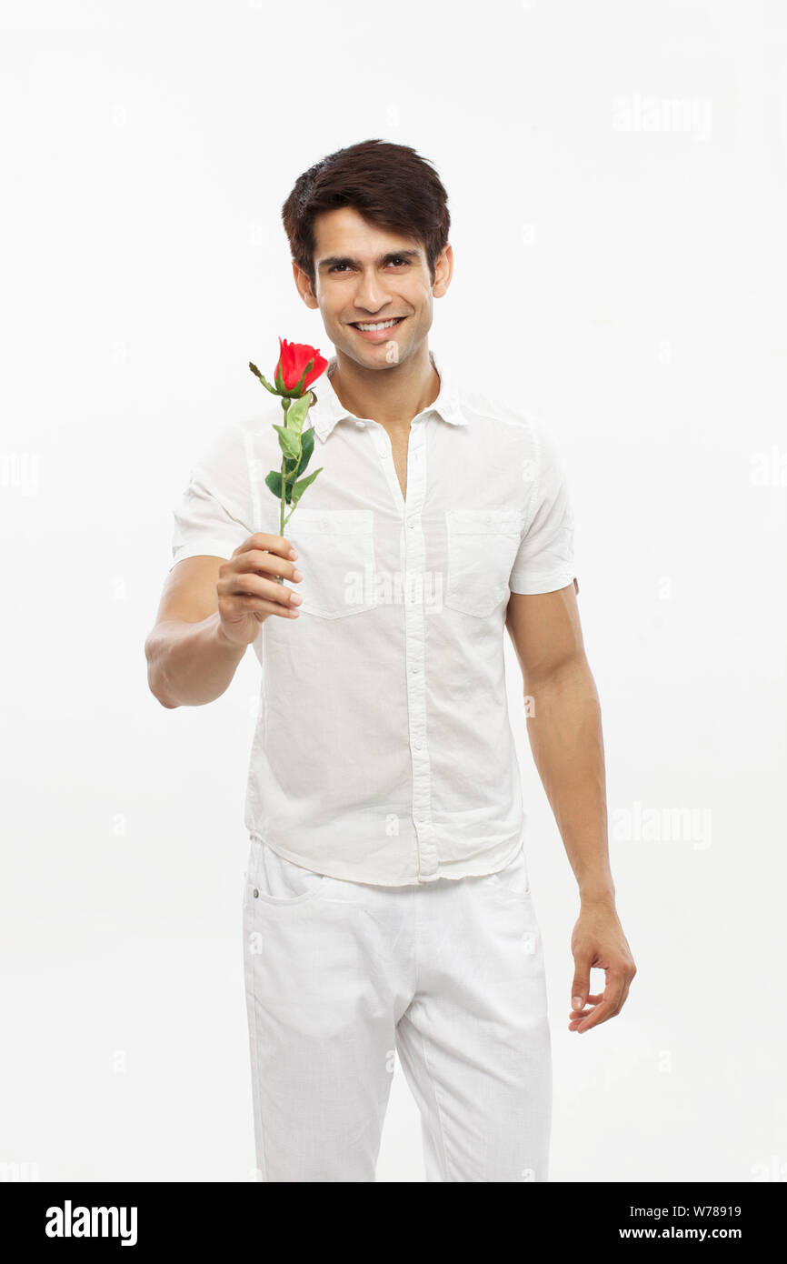 Romantic young man giving rose hi-res stock photography and images - Alamy