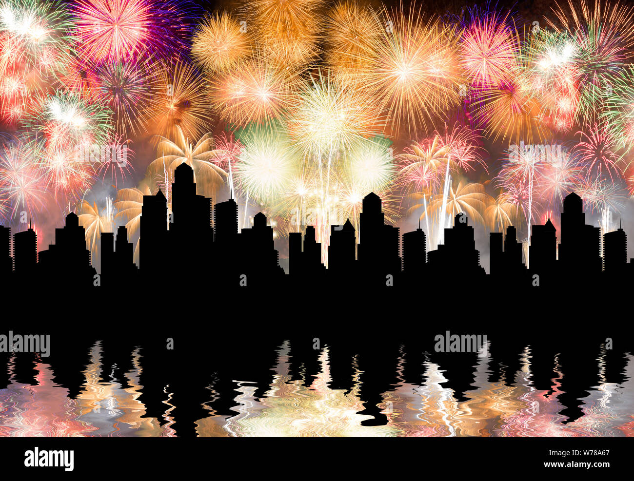 Lots of colorful fireworks in the sky above a silhouette of a big city ...