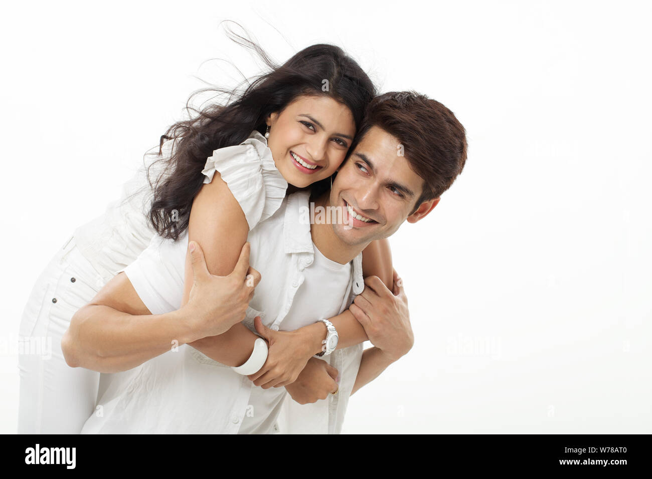 Young man giving a piggy back ride to a his wife Stock Photo - Alamy