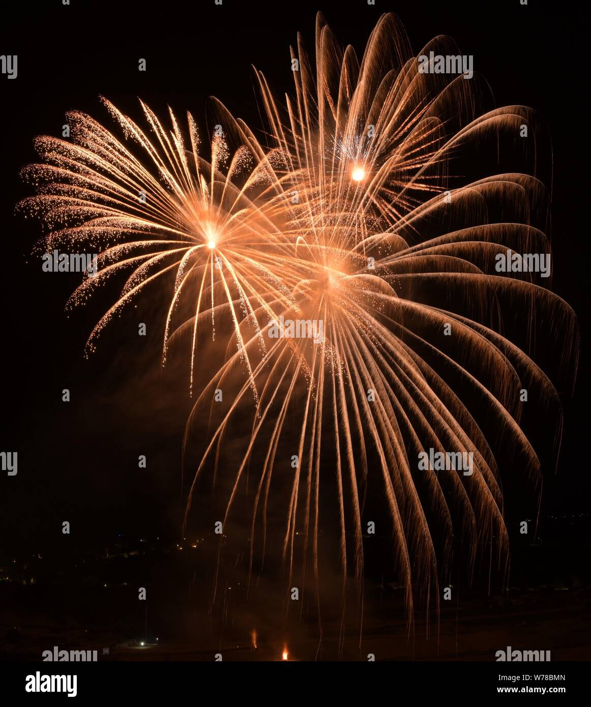 Fireworks bursts, triple orange/red Stock Photo - Alamy