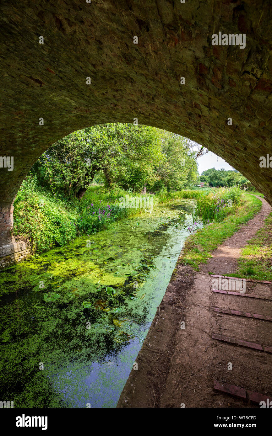 A view through the Wildmoorway canal bridge on the disused Thames and ...