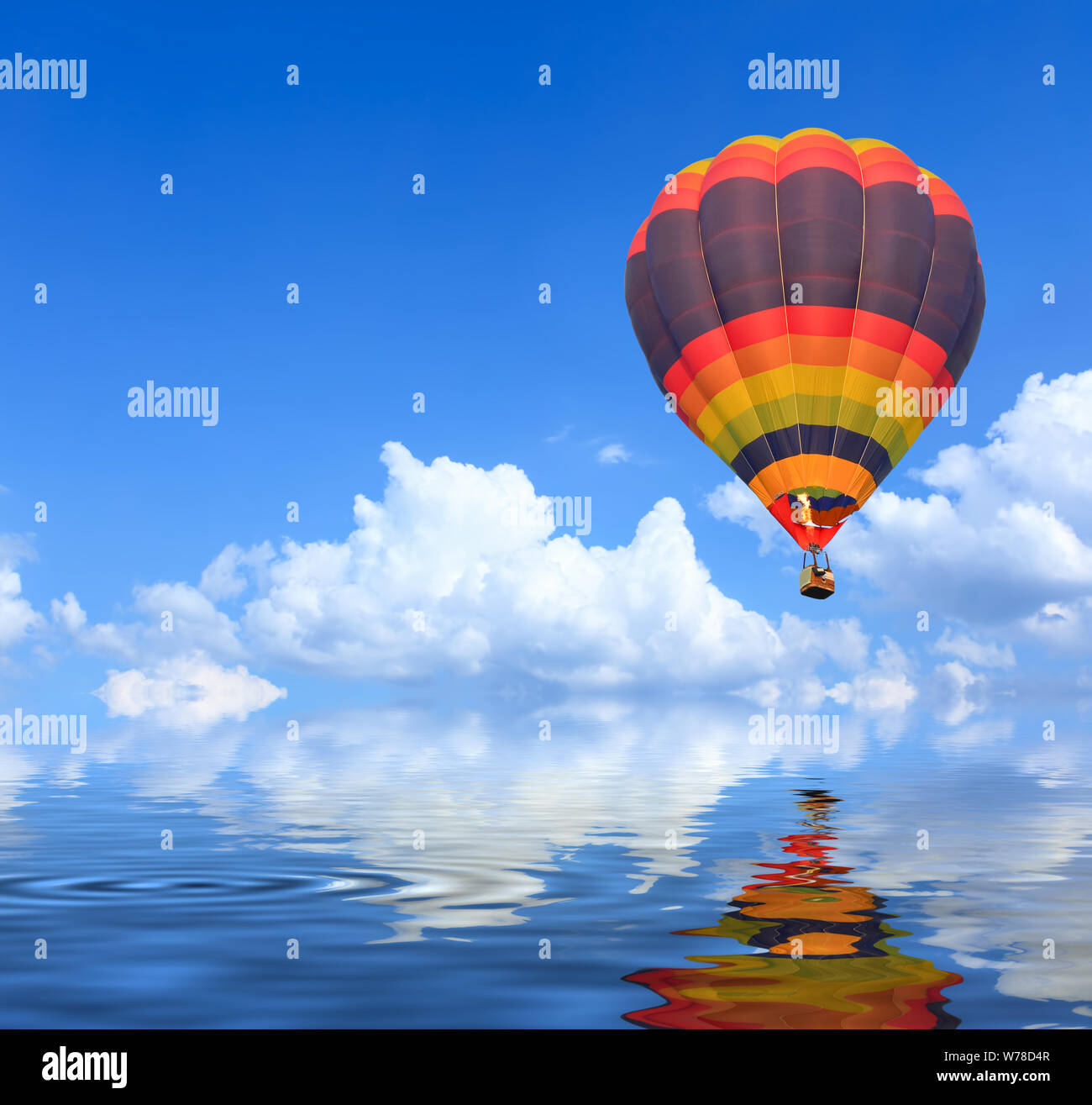 Colorful Hot Air Balloons in Flight over blue sky with water reflection ...