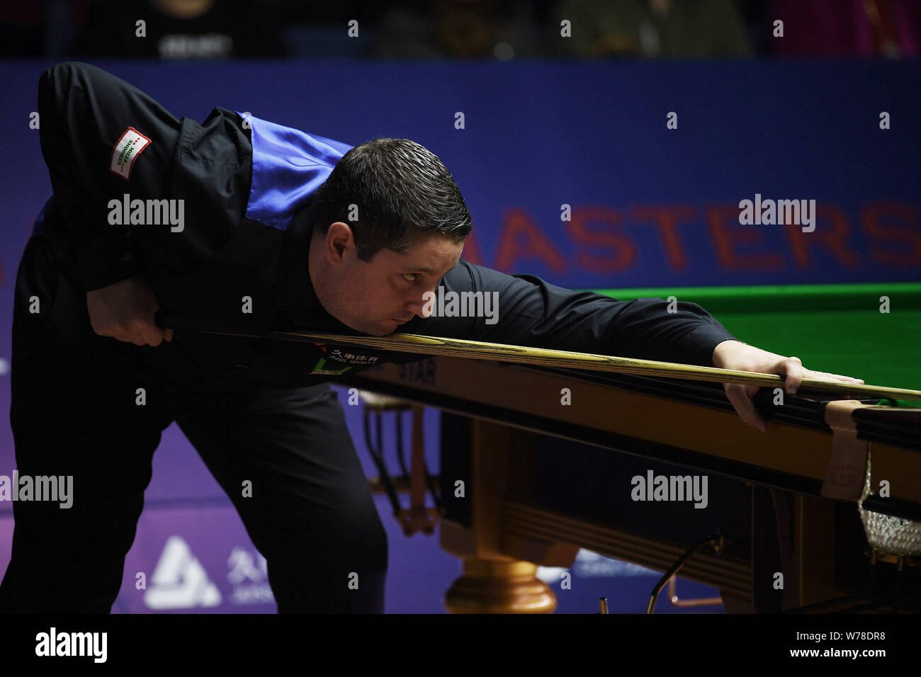 Stuart Carrington of England plays a shot to Ali Carter of England in ...