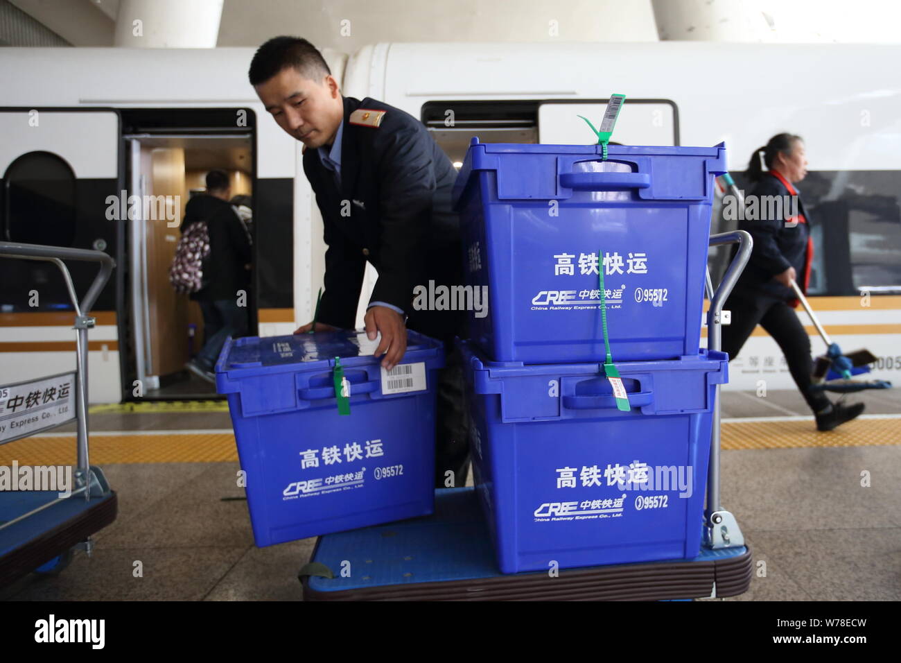 A Chinese employee of CRE (China Railway Express) moves the boxes with ...