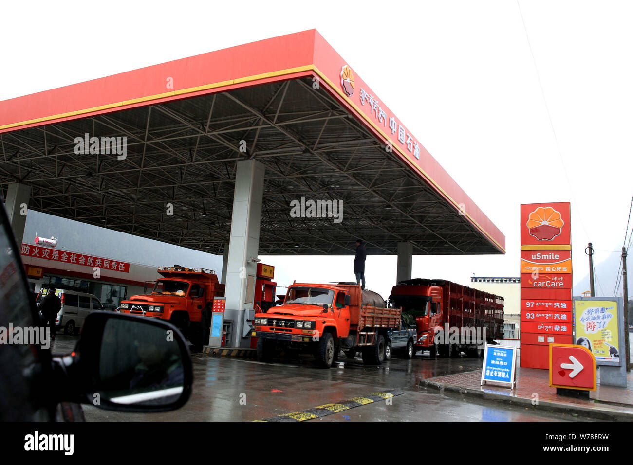--FILE--Cars are being refueled at a gas station of PetroChina, a ...
