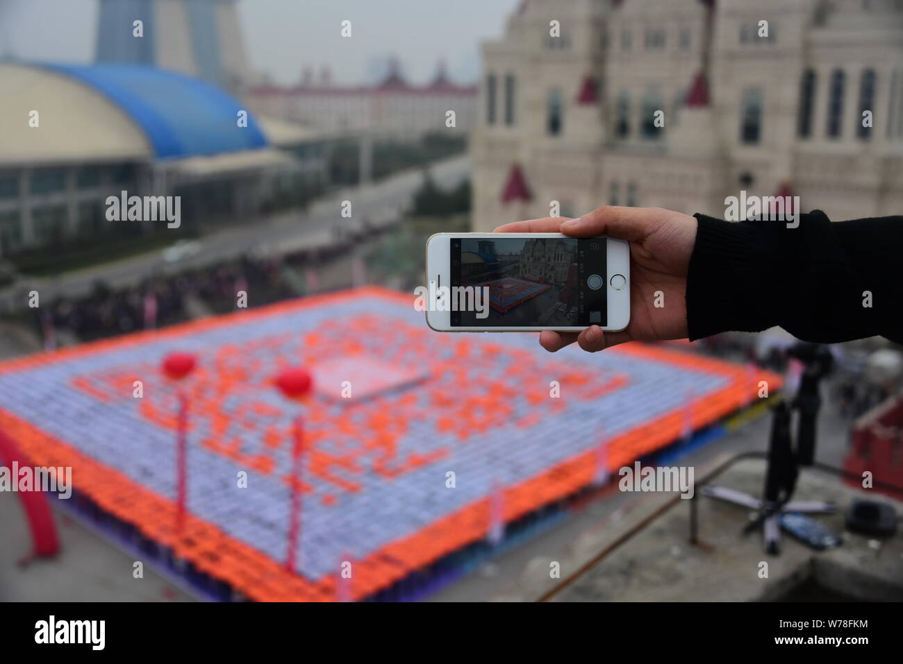 A Chinese mobilephone user uses his smartphone to scan the world's ...