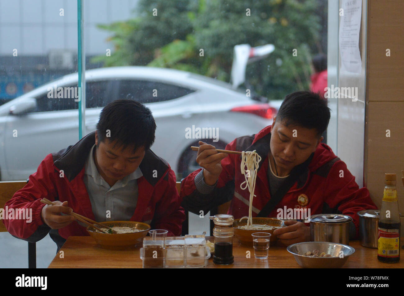 Chinese courier Mai Jiming and his colleague of Chinese online retailer ...