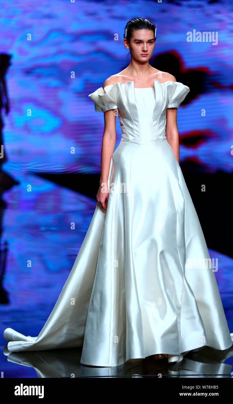 A model displays a new creation at the fashion show of Jusere by Yu ...