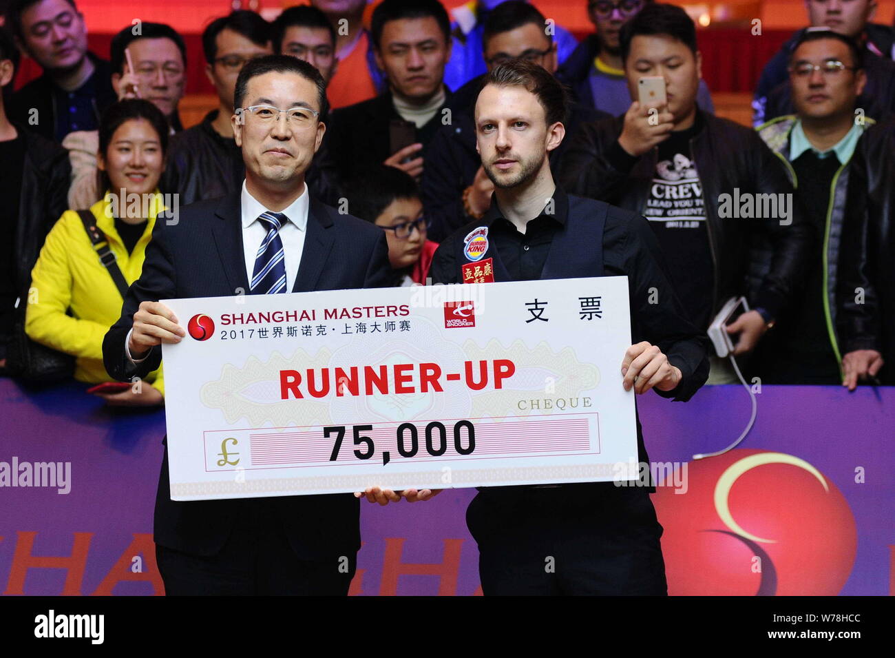 Judd Trump of England, right, poses with a runner-up cheque for ê75,000 ...