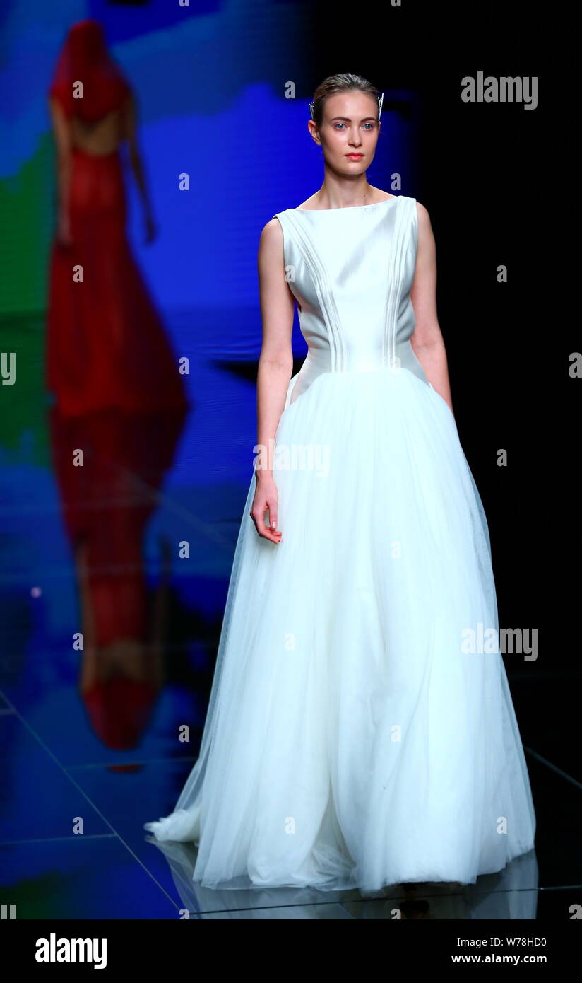 A model displays a new creation at the fashion show of Jusere by Yu ...