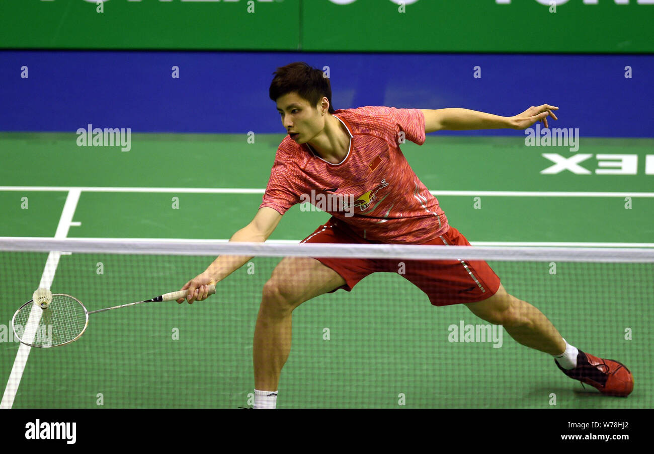 Shi Yuqi of China returns a shot to Lin Dan of China in their quarterfinal match of the men's ...