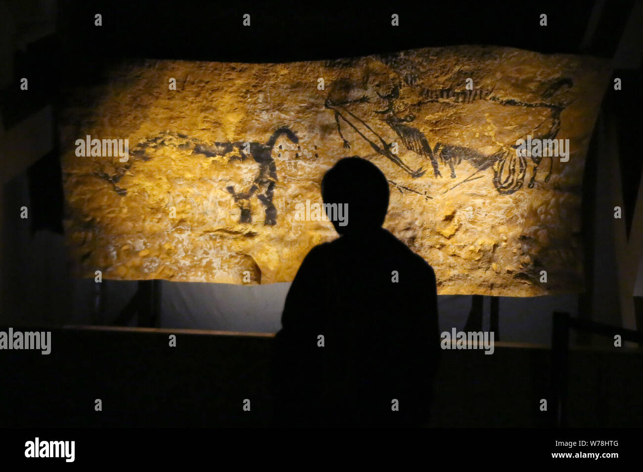 A visitor looks at ''The Shaft of the Dead Man'' showing a fight ...