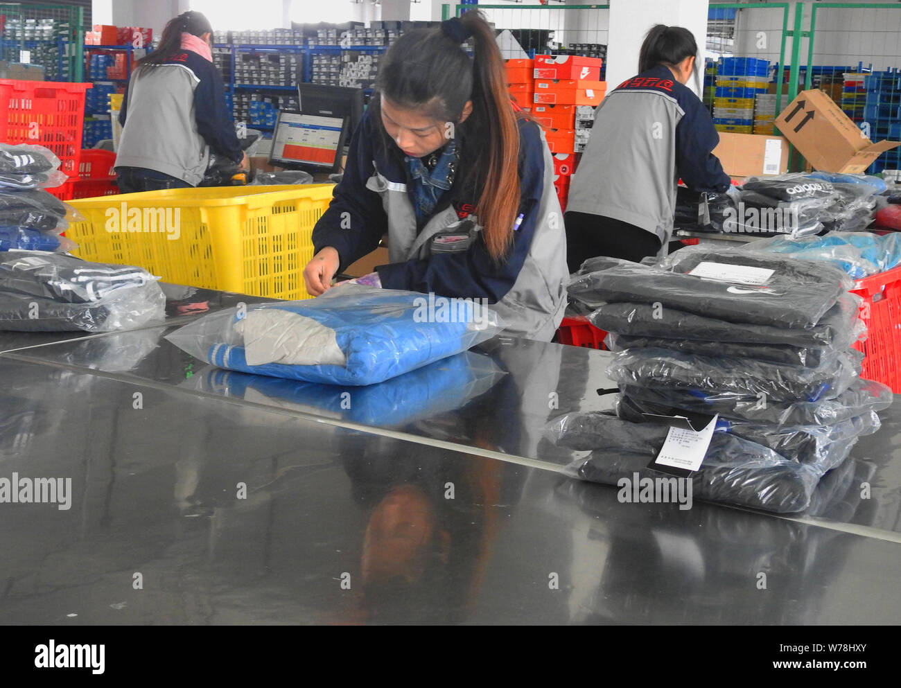 A Chinese worker prepares the shoes for the upcoming 11.11 global ...