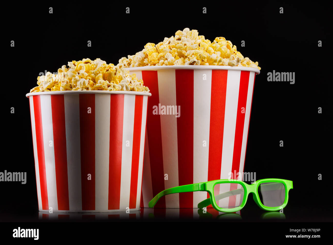 Paper striped buckets with popcorn and glasses isolated on black background Stock Photo - Alamy