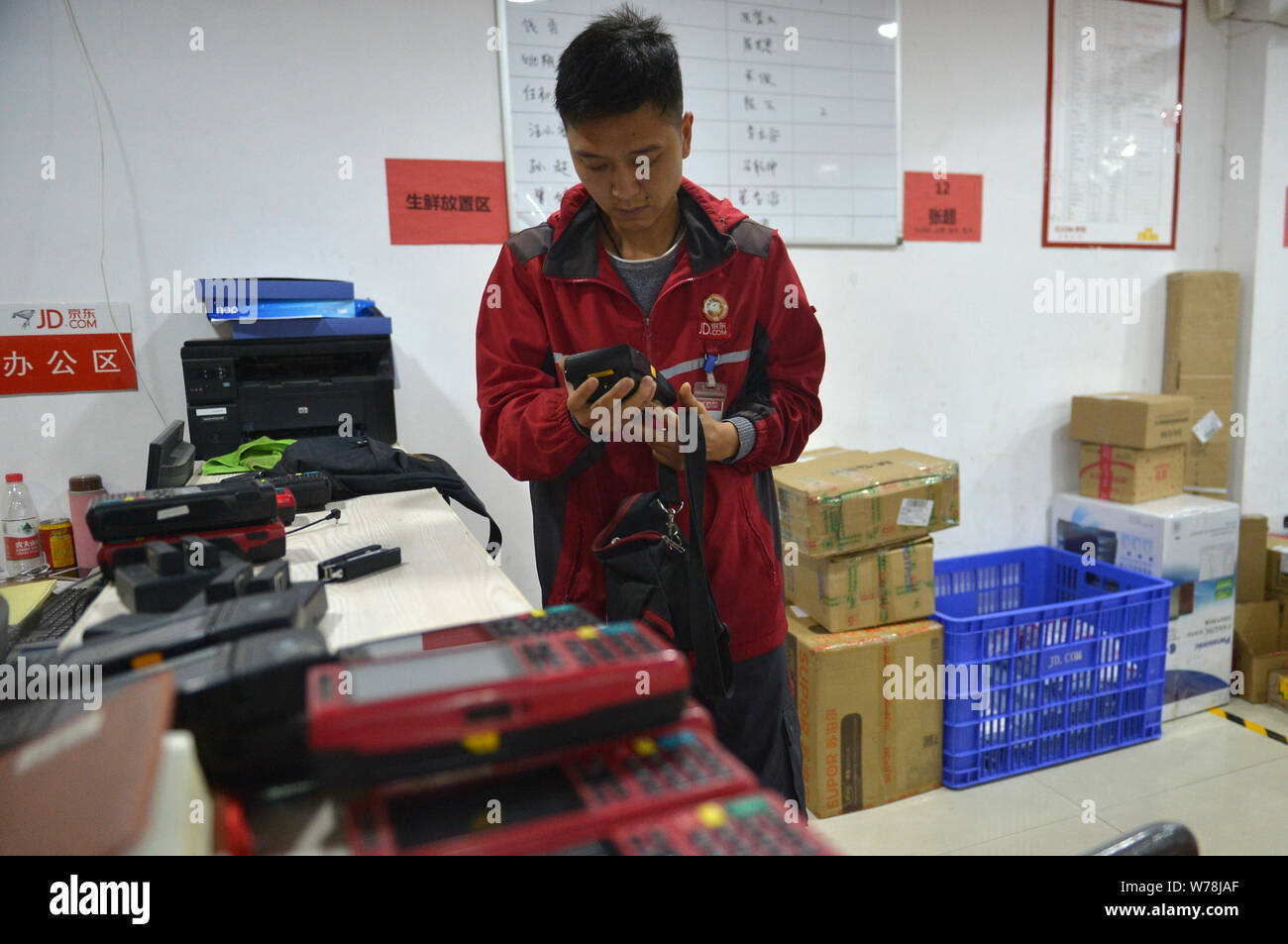 Chinese courier Mai Jiming of Chinese online retailer JD.com gets a POS ...