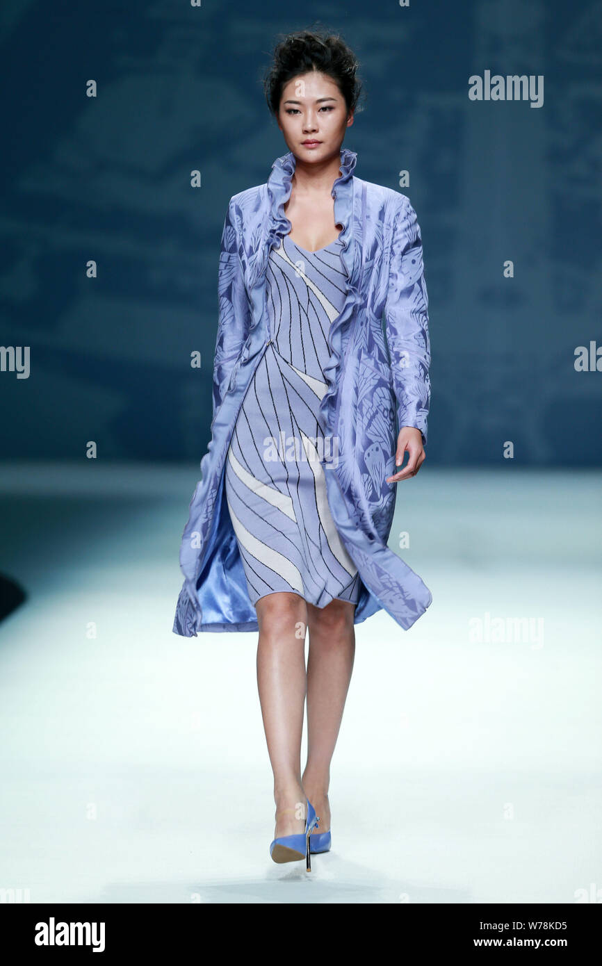 A model displays a new creation at the fashion show of 95.SY by Deng ...