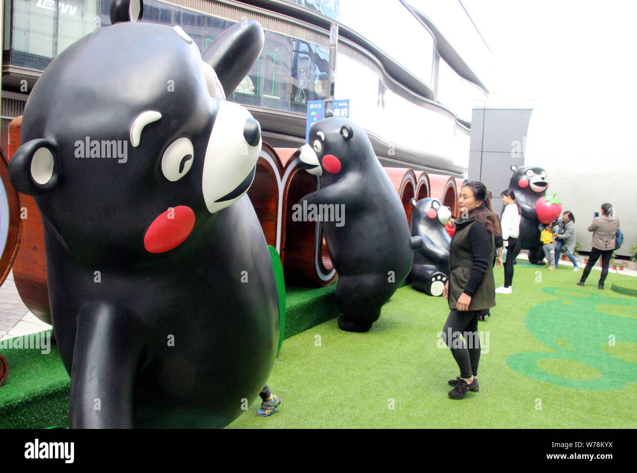 Chinese children and parents play with Kumamon sculptures at the ...