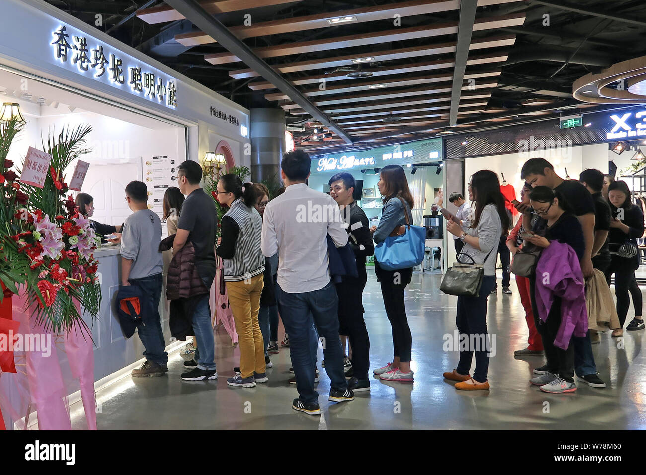 Chinese customers queue up to buy handmade butter cookies at the Jenny ...