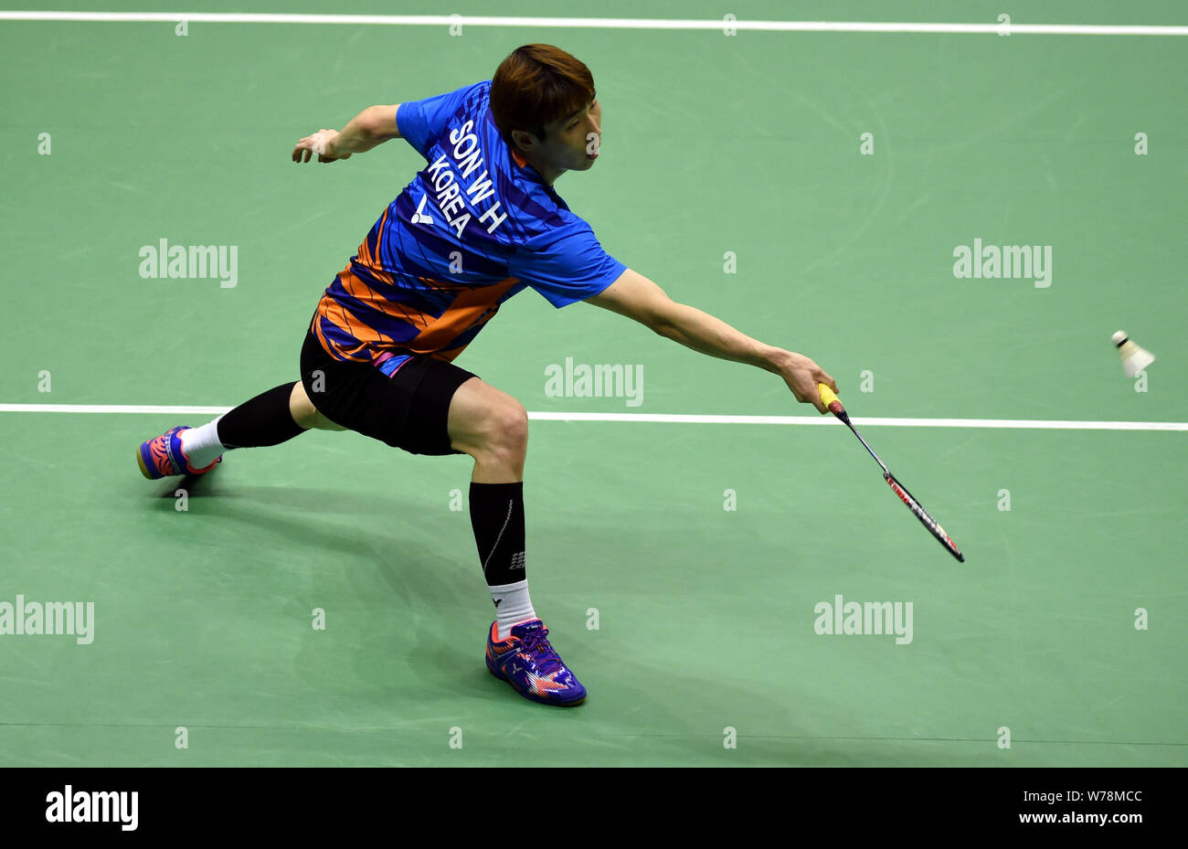 Son Wan-ho of South Korea returns a shot to Lee Chong Wei of Malaysia ...