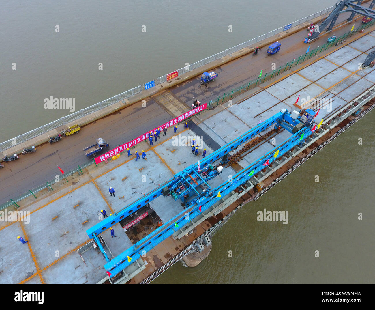 Chinese workers install the last steel bridge deck at the site of a ...