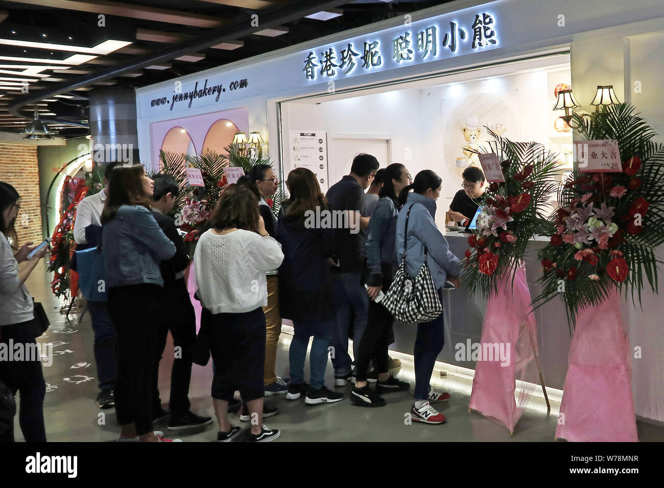Chinese customers queue up to buy handmade butter cookies at the Jenny ...