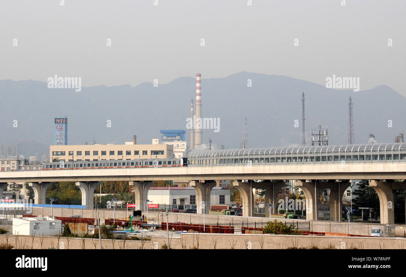 A metro train runs on the Yanfang Line, the China's first fully ...