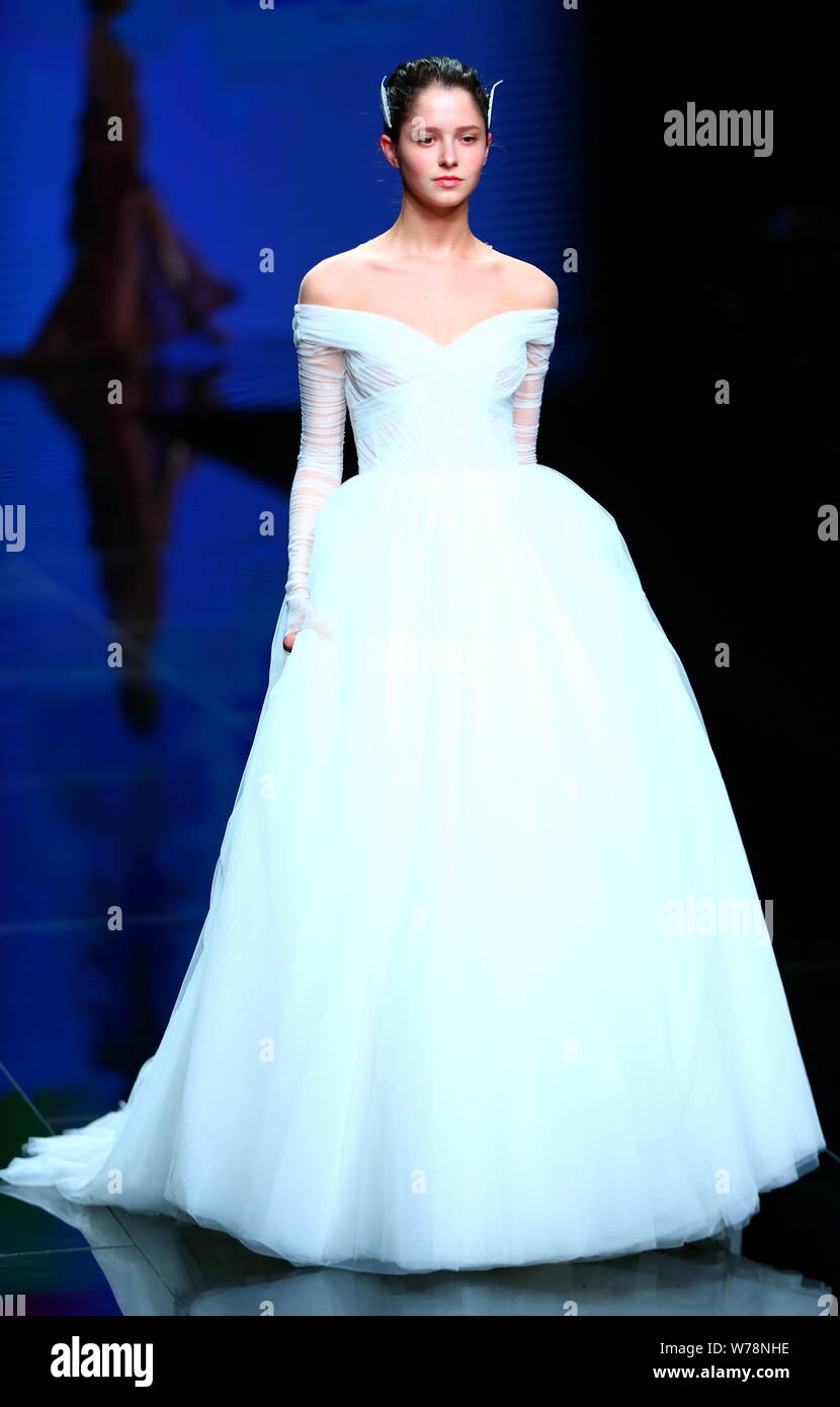 A model displays a new creation at the fashion show of Jusere by Yu ...