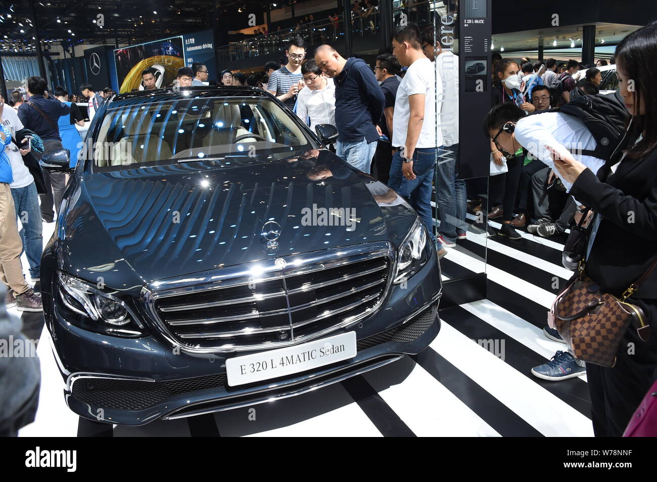 --FILE--Visitors look at a Mercedes-Benz E 320 L 4MATIC Sedan during ...