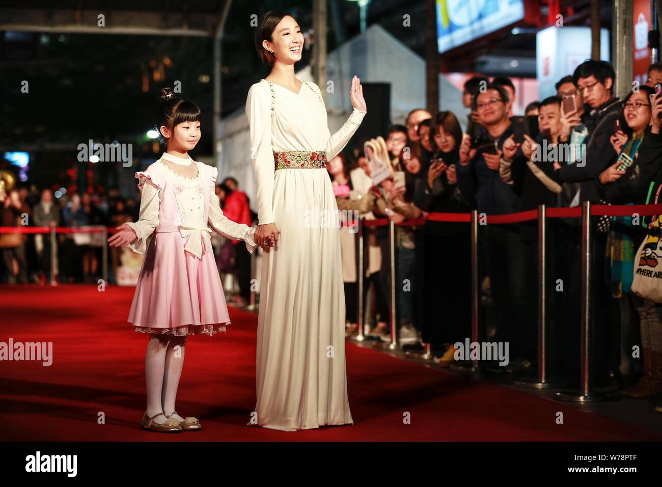 Taiwanese actress Gwei Lun-mei, right, poses as she arrives on the red ...