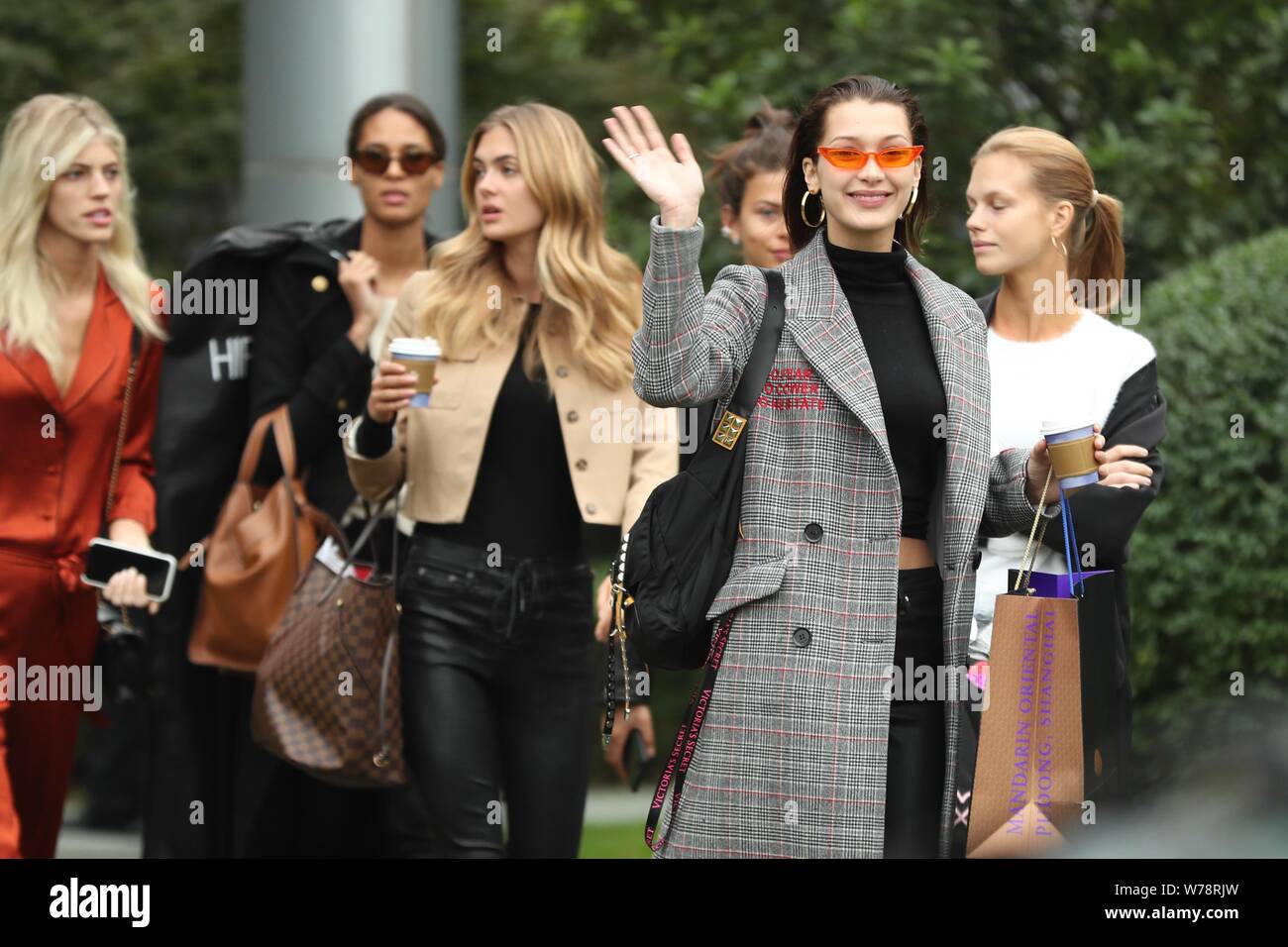 Victoria's Secret Angel and American model Bella Hadid, right, waves as ...