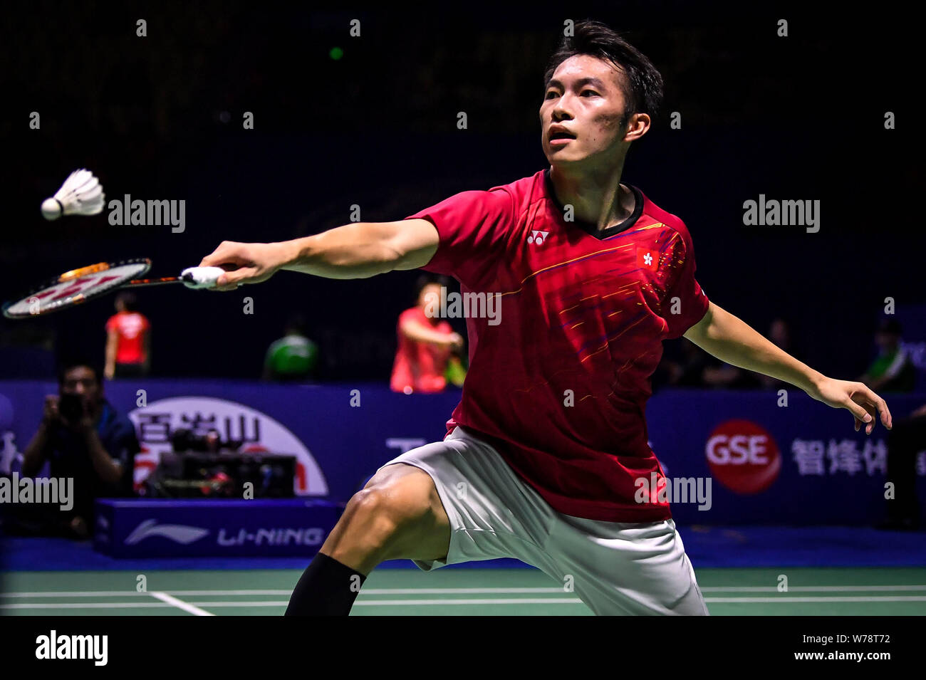 Angus Ng of Hong Kong returns a shot to Lee Chong Wei of Malaysia in ...